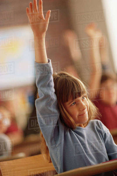 Student raising hand in classroom - Royalty-free Stock Photo | Dissolve