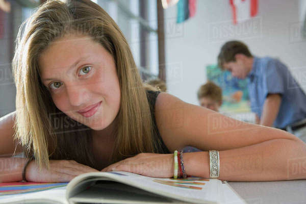 Girl reading in library - Royalty-free Stock Photo | Dissolve