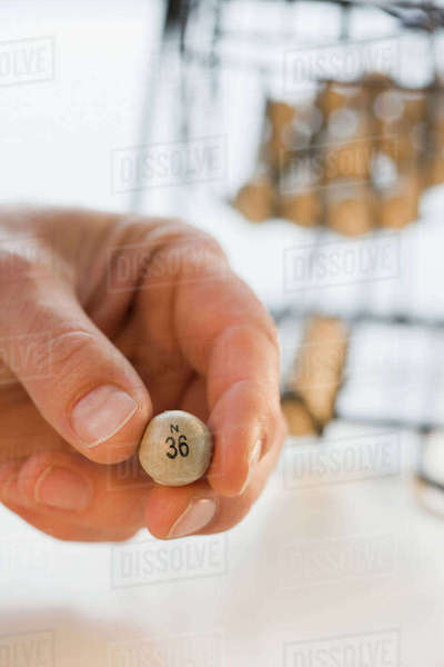 Man holding bingo ball - Royalty-free Stock Photo | Dissolve