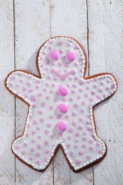 A gingerbread man decorated with pink dots - Royalty-free Stock Photo | Dissolve