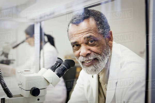 African American scientist using microscope in laboratory - Stock Photo ...
