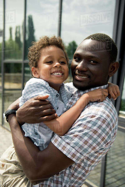 Portrait Of Beautiful Smiling African American Father And Son Hugging