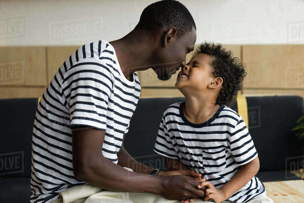 Side View Of Happy African American Father And Son Touching Noses And