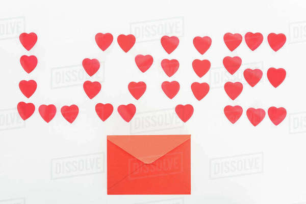 Top view of envelope and lettering love made of heart symbols isolated ...