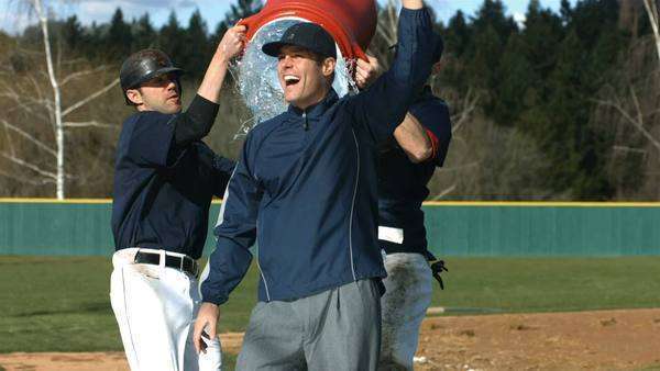 Baseball players pour cooler of water over coach, slow motion - Stock ...