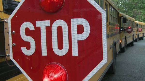 Bus stop sign with hazard lights on. - Stock Video Footage - Dissolve