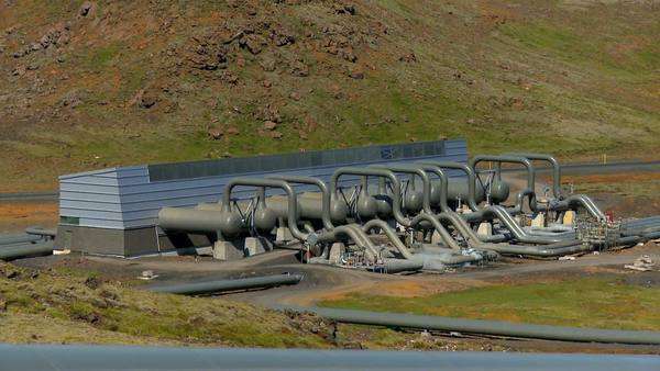 Steam for geothermal energy being piped from natural volcanic hot ...