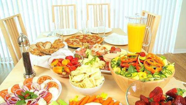 Modern family dining table full of fresh tasty food for a healthy diet ...