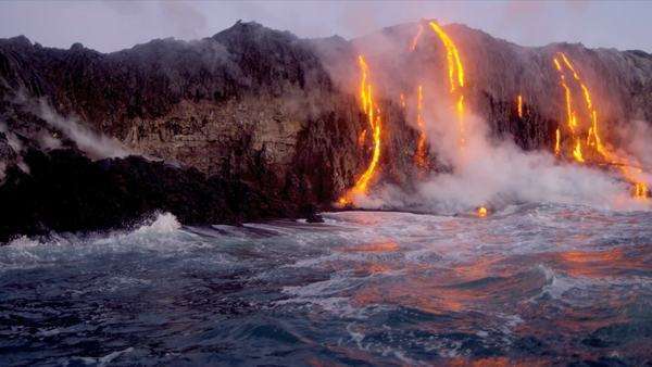 Red hot lava falling into ocean Kilauea Hawaii causing rising steam ...