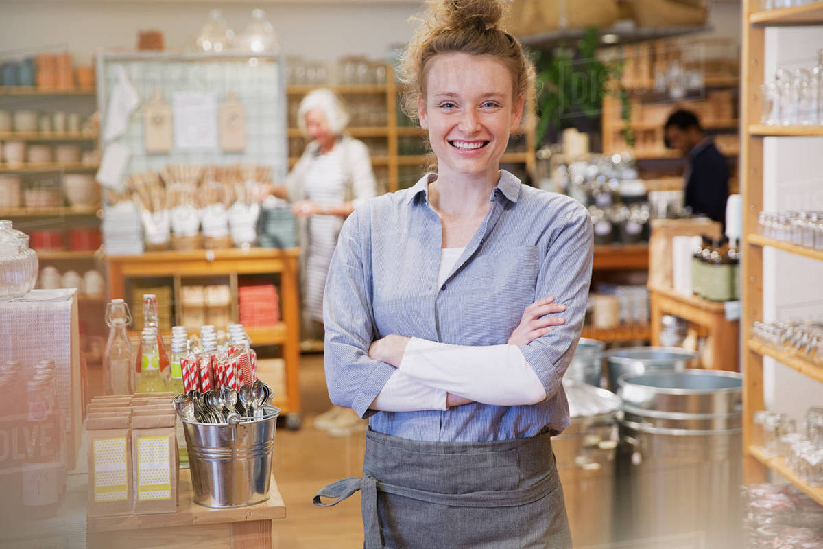 Portrait smiling female business owner working in shop - Stock Photo ...