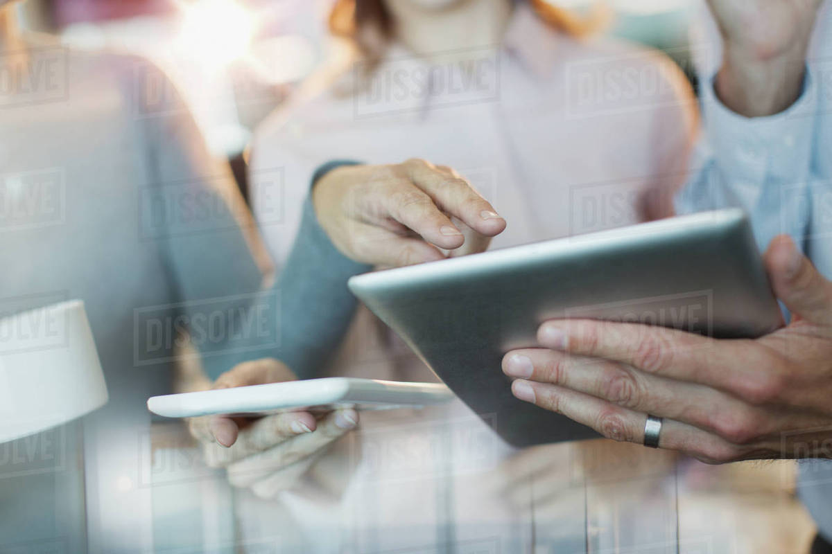 Close up business people using digital tablets - Stock Photo - Dissolve