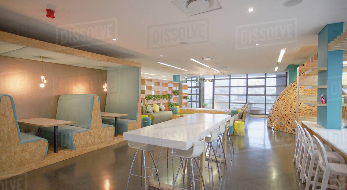 Modern, creative shared workspace with table and booths - Royalty-free ...