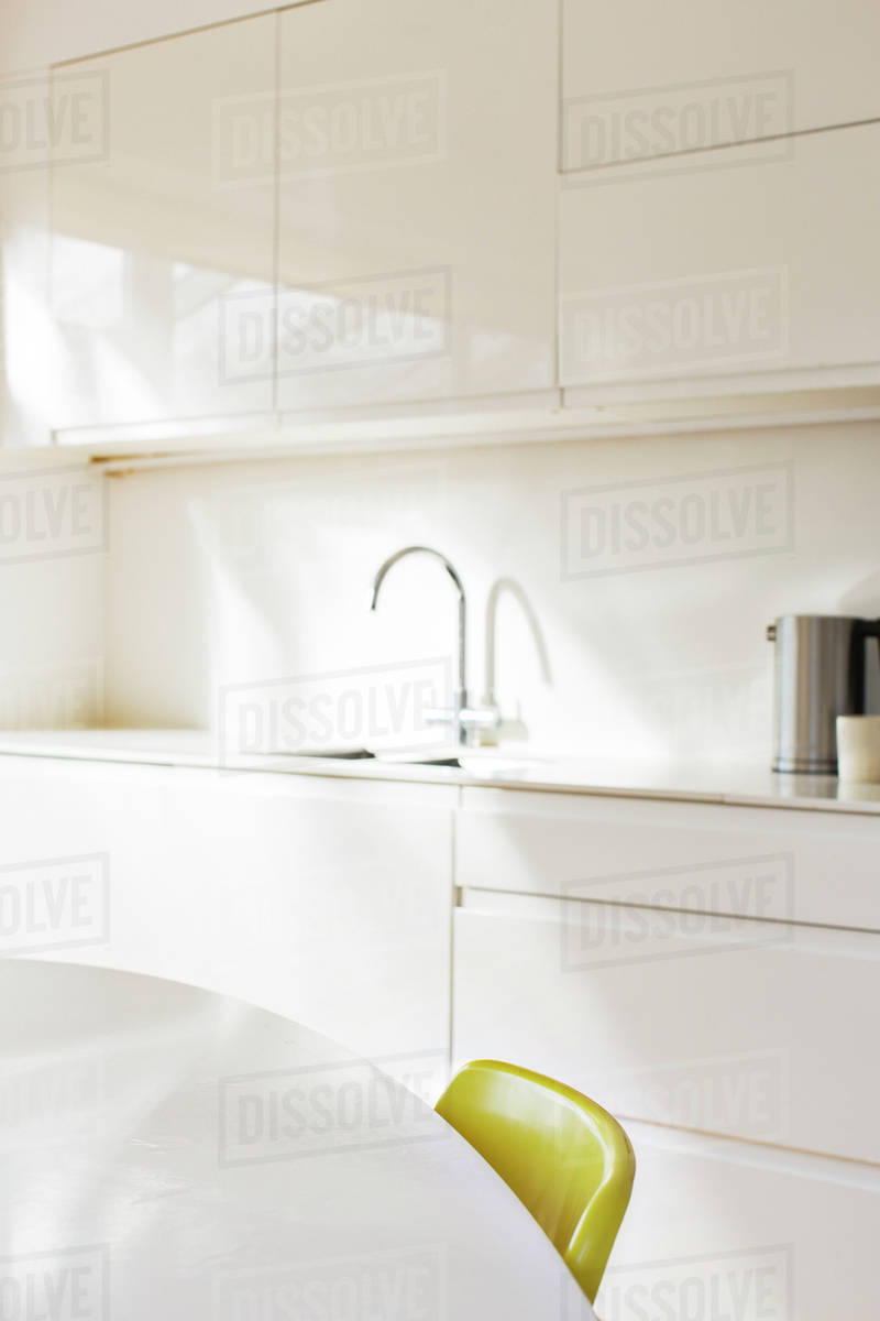 Simple faucet in modern white kitchen - Royalty-free Stock Photo | Dissolve