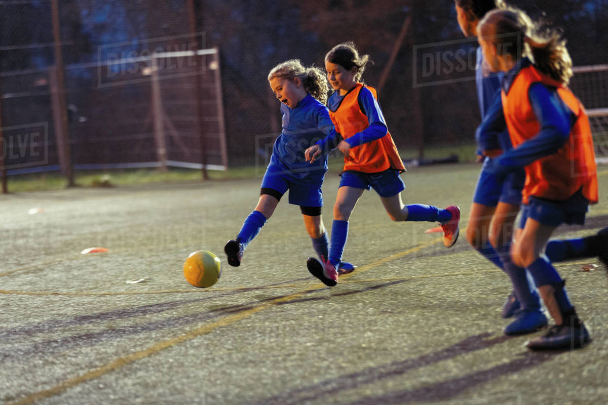 Girls soccer team practicing on field at night - Royalty-free Stock ...