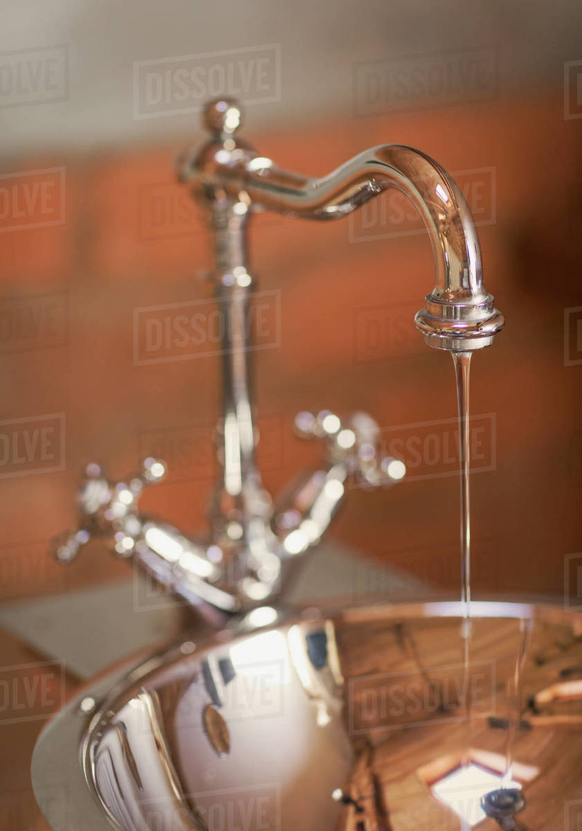 Close up water flowing from stainless still sink and basin - Stock ...