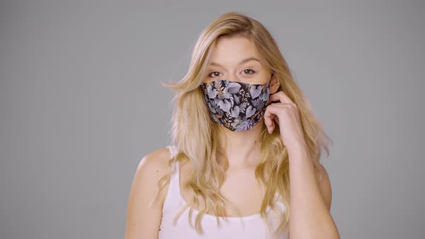 Content woman taking off mask and looking at camera - Stock Video ...