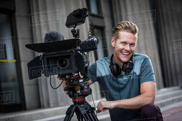 Portrait of smiling camera operator - Royalty-free Stock Photo | Dissolve