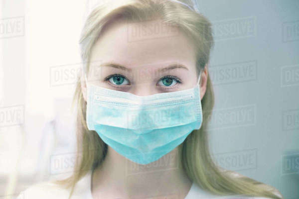 Portrait of young woman wearing surgical mask - Royalty-free Stock ...