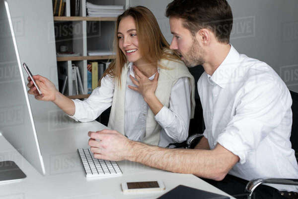 Businesspeople using computer together - Royalty-free Stock Photo ...