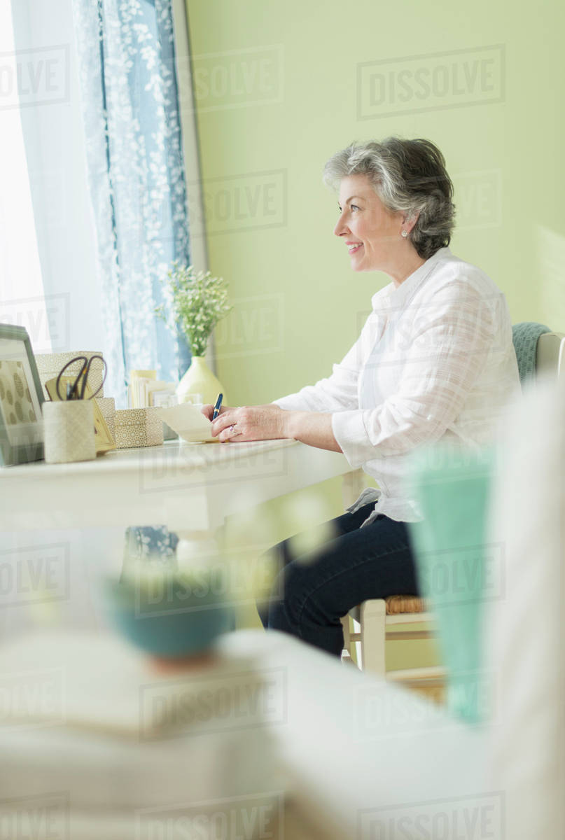 Mature woman writing letter - Stock Photo - Dissolve