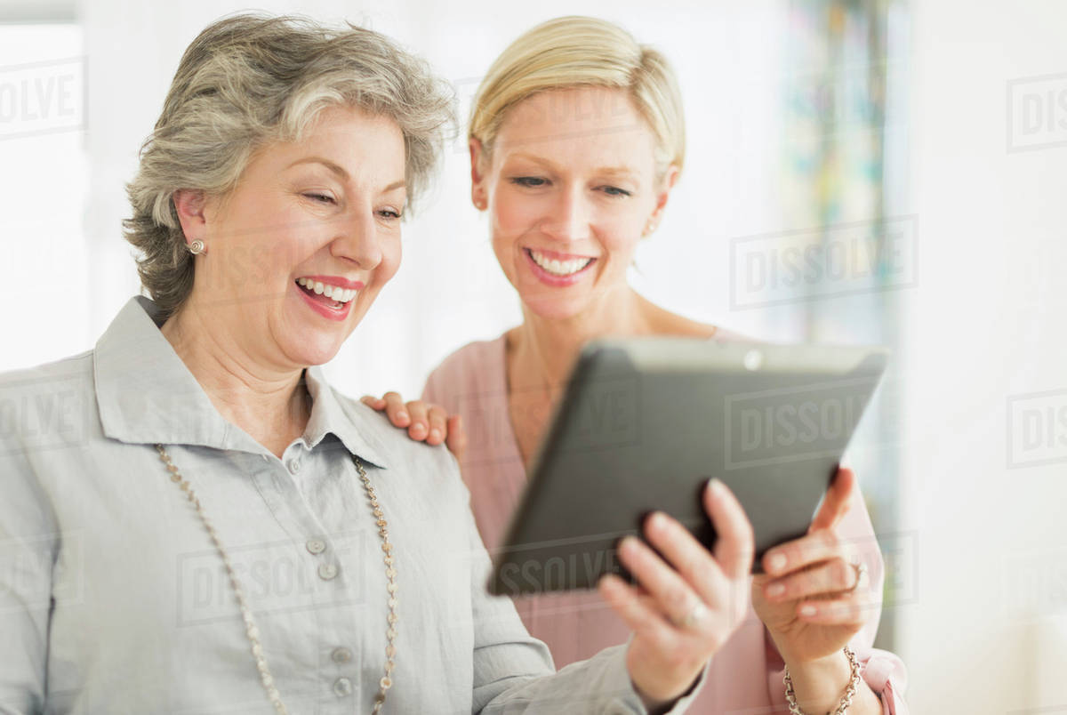 Portrait of two women using digital tablet - Royalty-free Stock Photo ...