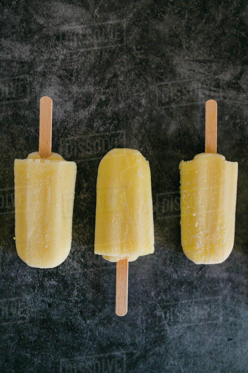 Row of lemon ice pops - Royalty-free Stock Photo | Dissolve