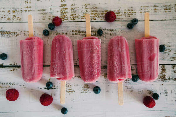 Row of berry ice pops with berries - Royalty-free Stock Photo | Dissolve