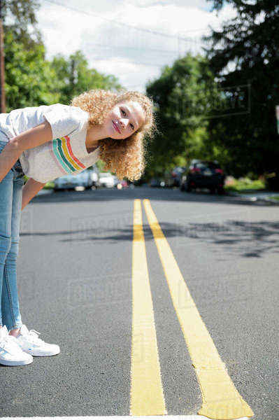 Girl leaning over on road - Royalty-free Stock Photo | Dissolve