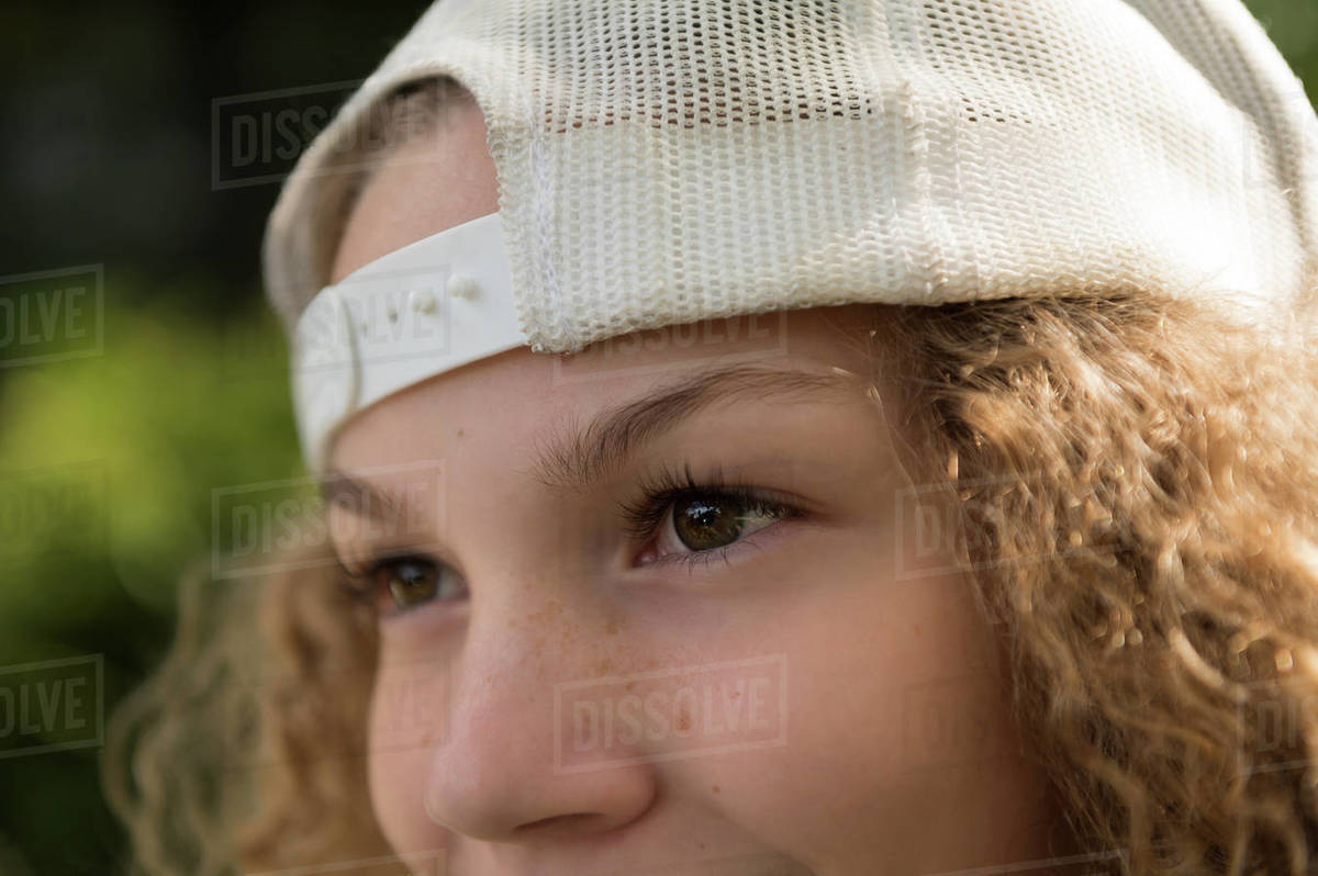 Close up of girl wearing baseball cap - Royalty-free Stock Photo | Dissolve