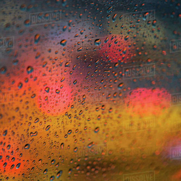 Defocussed light behind wet window - Stock Photo - Dissolve
