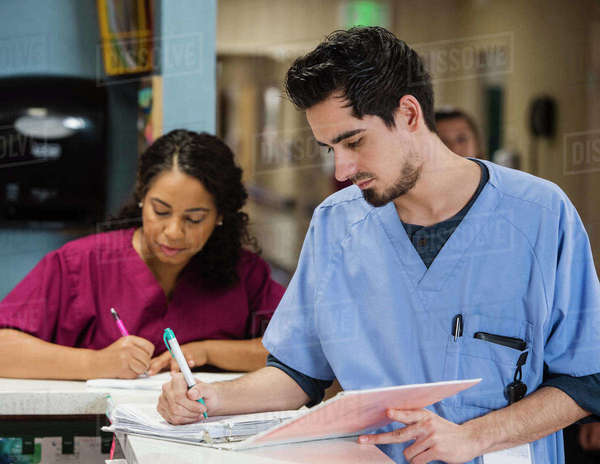 Nurses doing paperwork - Stock Photo - Dissolve