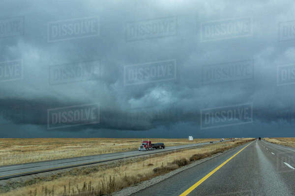 Truck on highway under overcast sky - Stock Photo - Dissolve