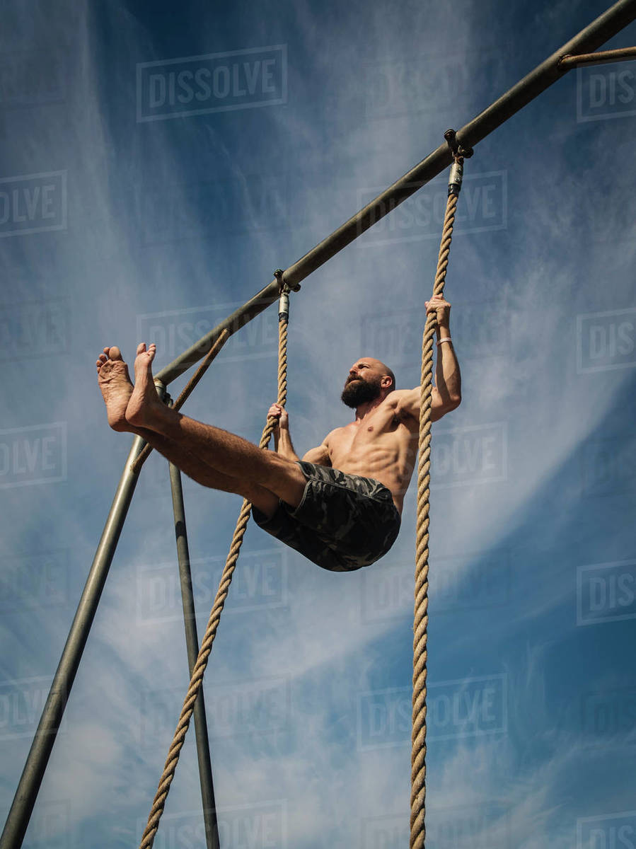 Man exercising on rope - Royalty-free Stock Photo | Dissolve