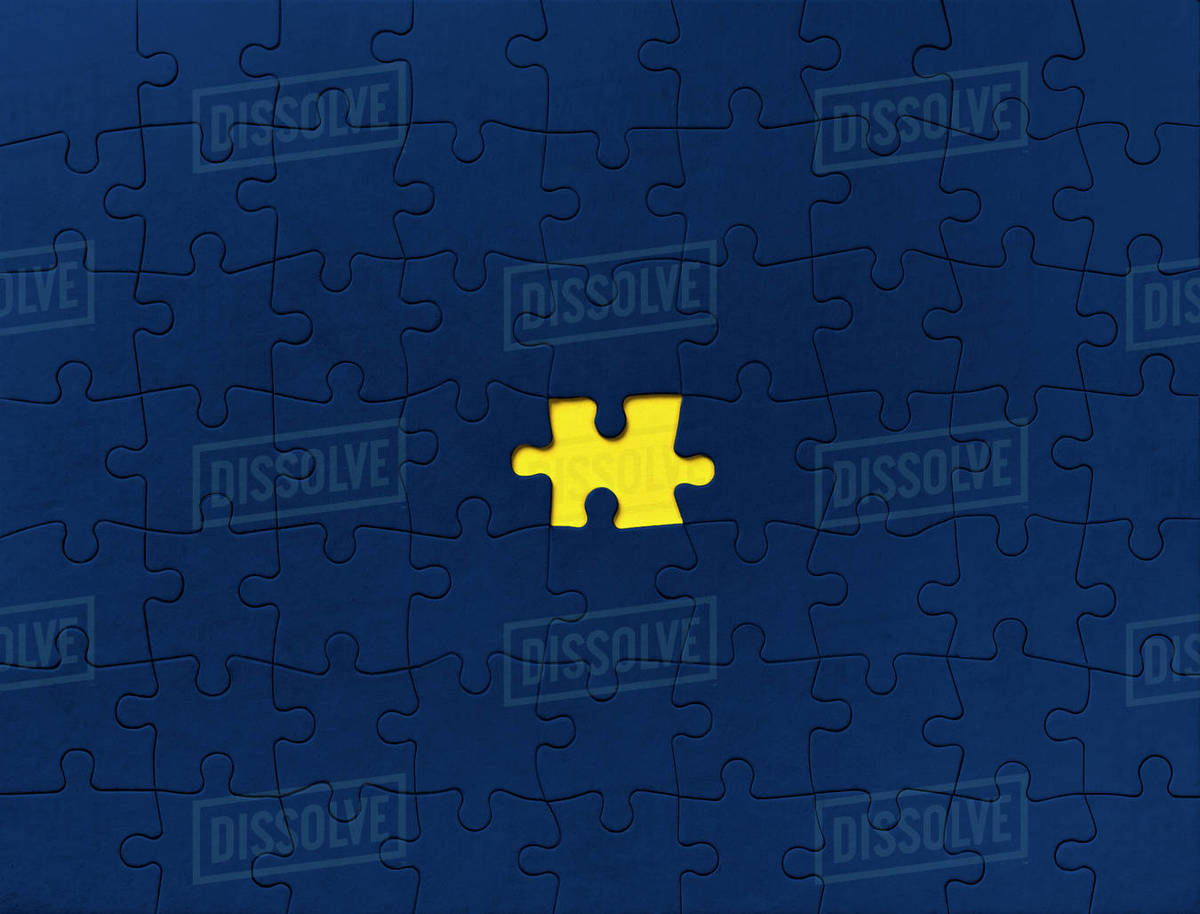 Yellow puzzle on blue background - Stock Photo - Dissolve