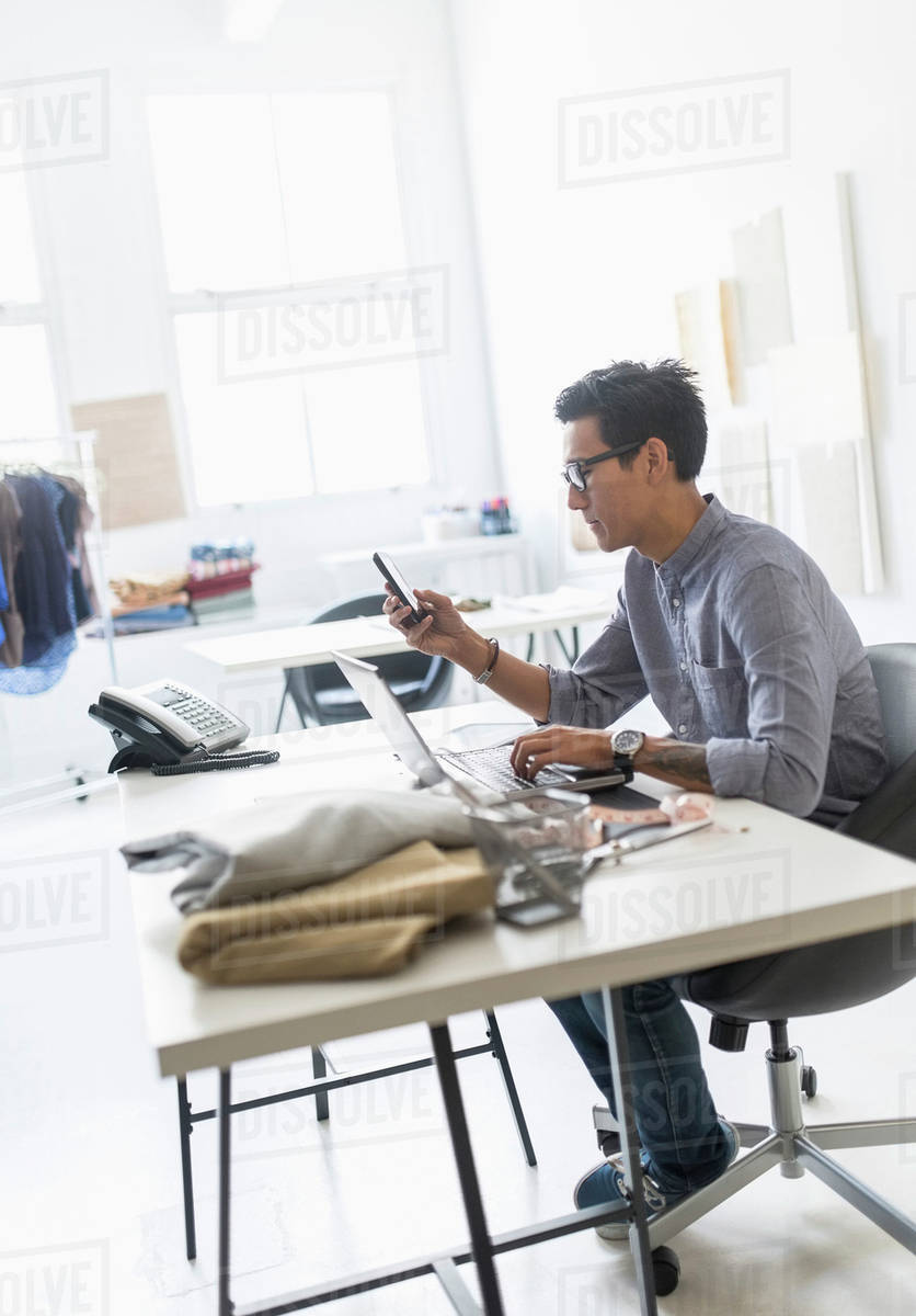 Side view of man working in studio - Stock Photo - Dissolve