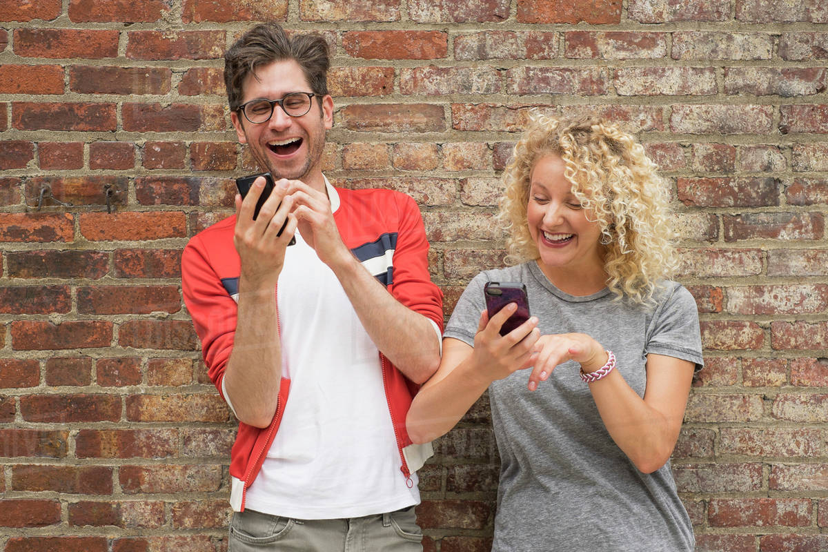 Couple using cell phones - Royalty-free Stock Photo | Dissolve