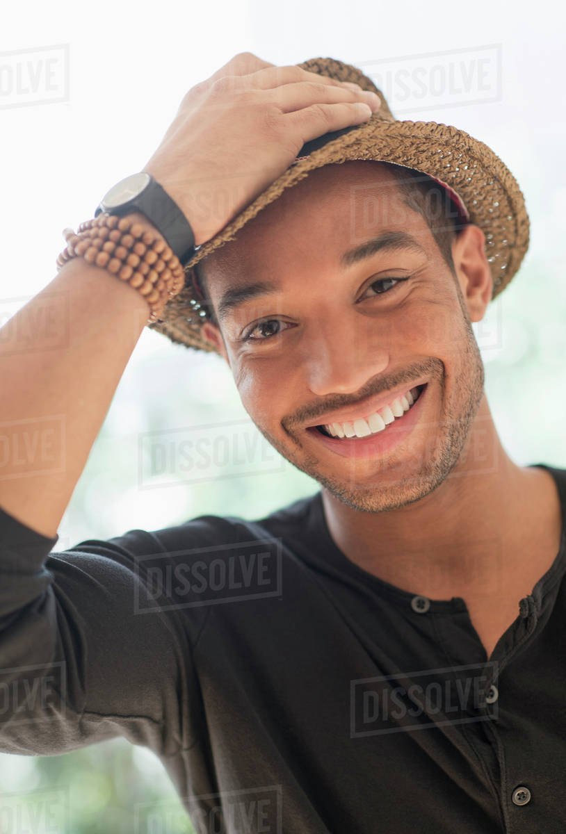 Portrait of smiling man in straw hat - Stock Photo - Dissolve