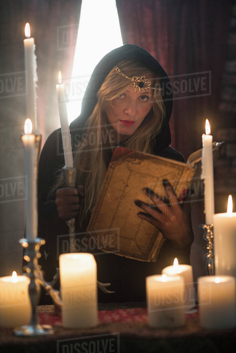 Portrait of sorceress in dark room - Stock Photo - Dissolve