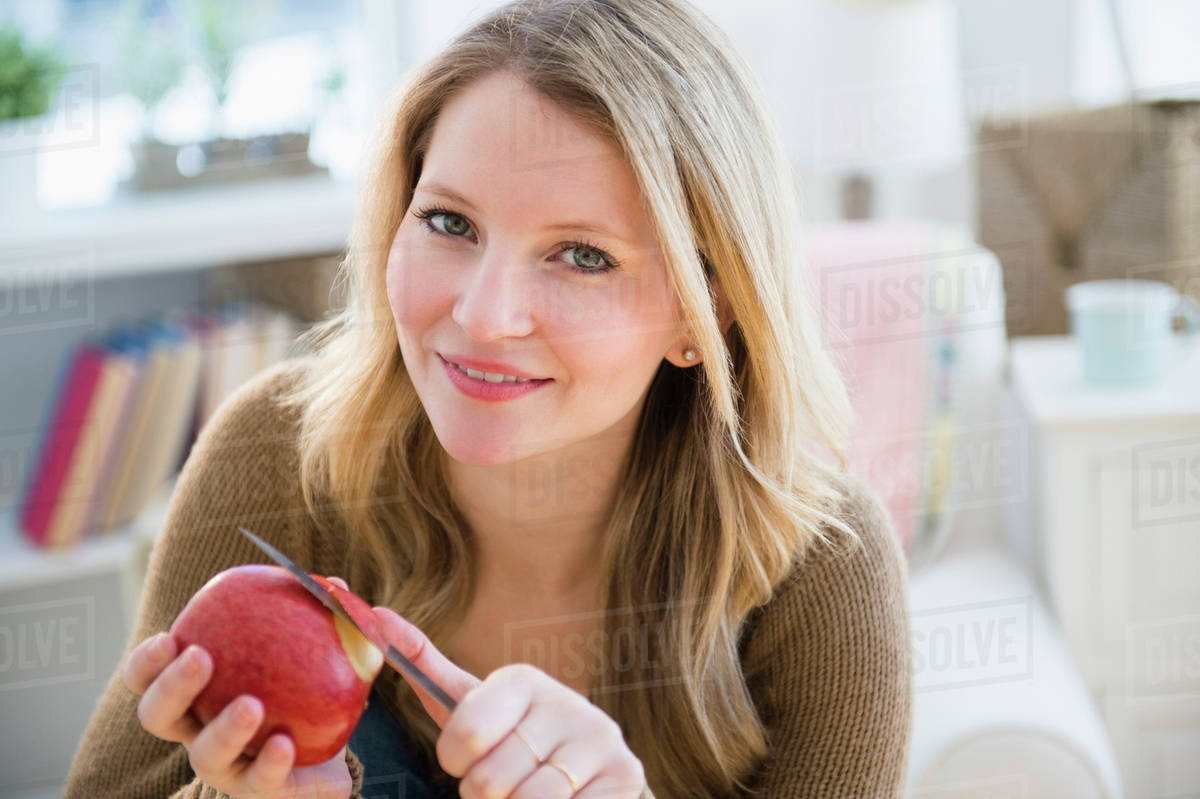 Woman peeling apple - Royalty-free Stock Photo | Dissolve