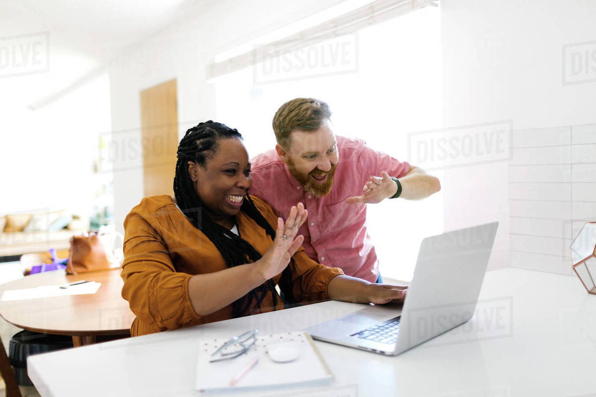 Man and woman during zoom call at home - Stock Photo - Dissolve