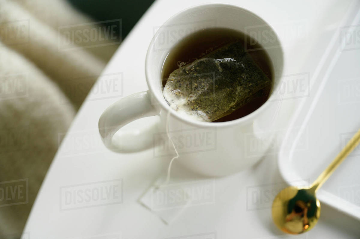 Mug with tea on table - Royalty-free Stock Photo | Dissolve