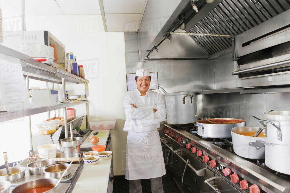 Hispanic cook in commercial kitchen - Royalty-free Stock Photo | Dissolve