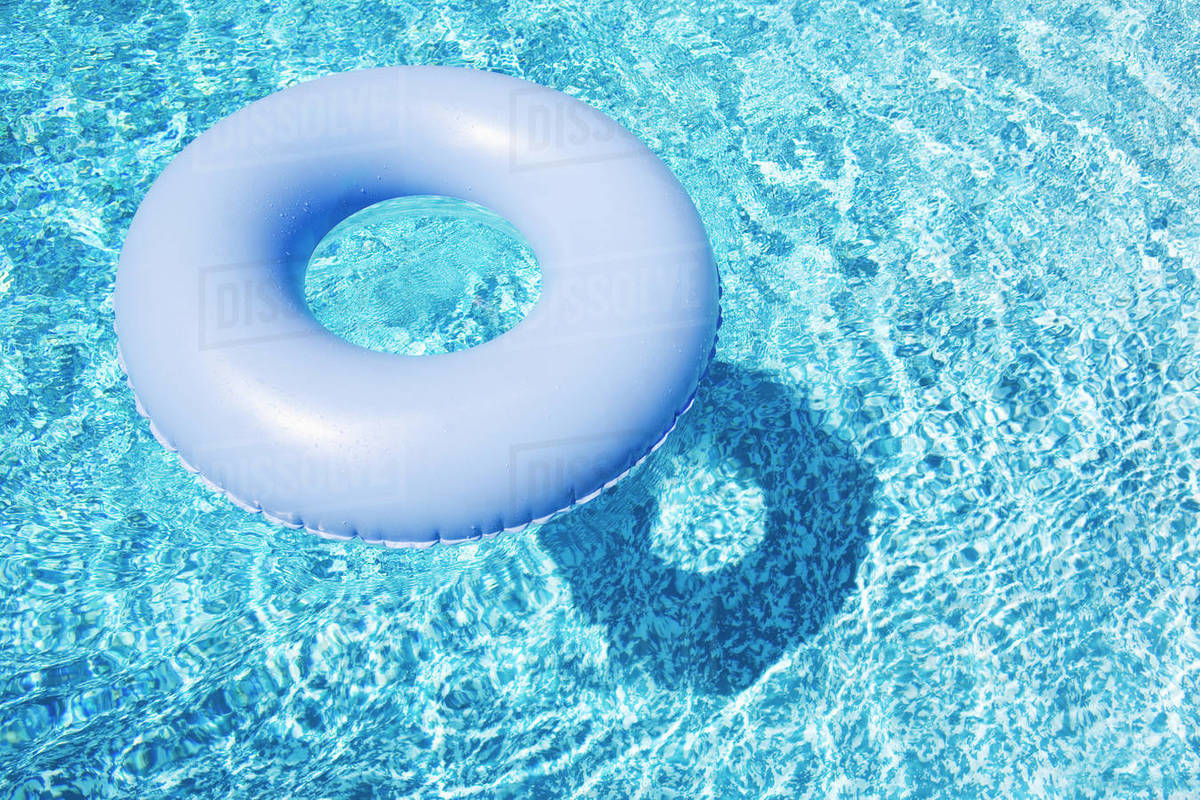 Blue inflatable ring floating on pool water surface - Royalty-free ...