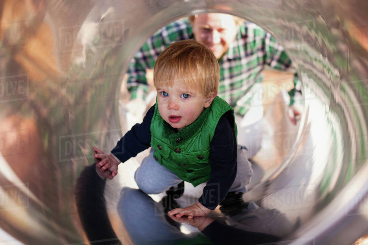 Boy climbing up slide in playground - Royalty-free Stock Photo | Dissolve