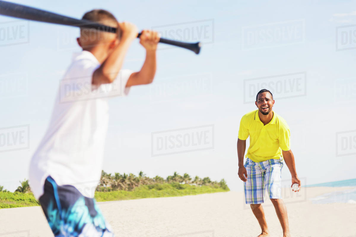Father and son (10-11) playing baseball on beach - Royalty-free Stock ...