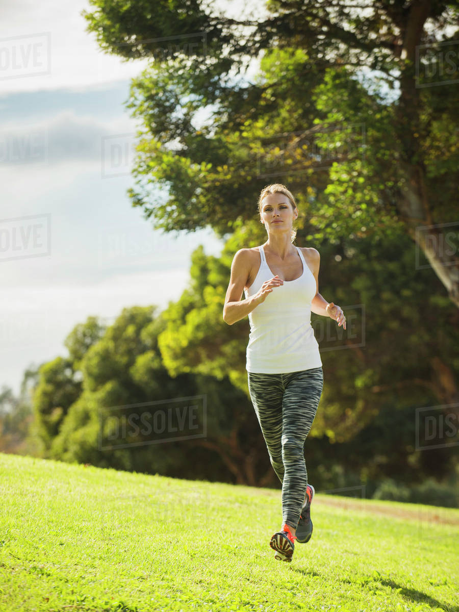 Woman running through lawn - Royalty-free Stock Photo | Dissolve