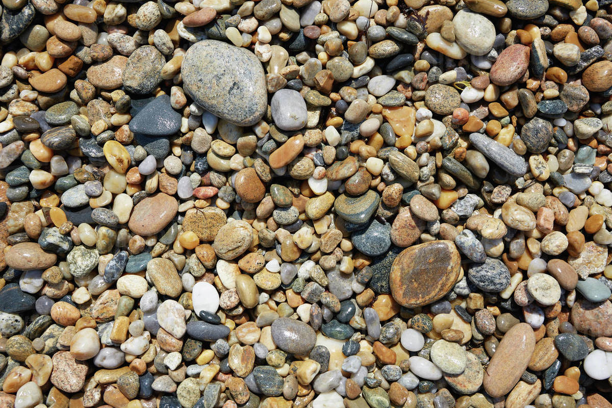 Overhead view of wet stones on beach - Royalty-free Stock Photo | Dissolve