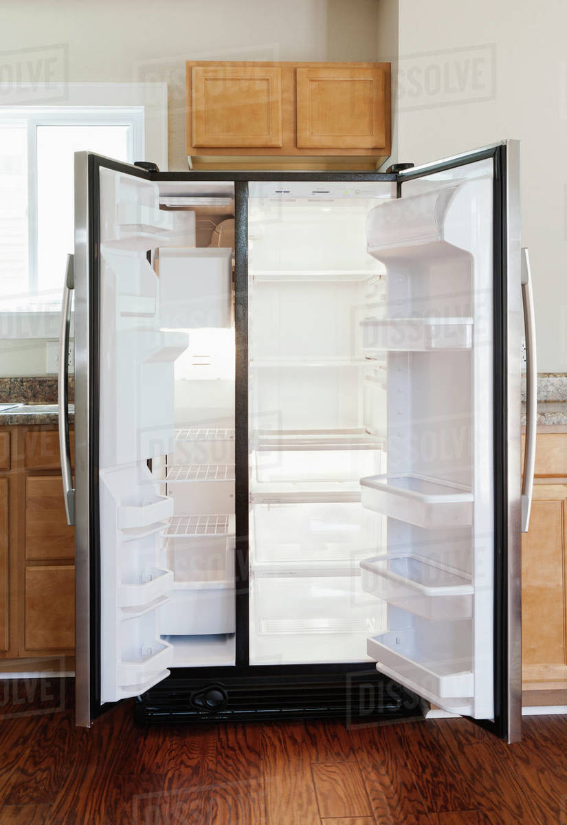 Empty open fridge in domestic kitchen - Royalty-free Stock Photo | Dissolve