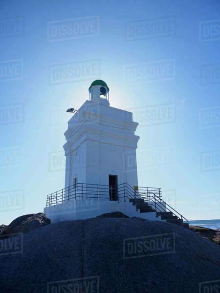 South Africa, Western Cape, St Helena, White lighthouse on sea coast ...
