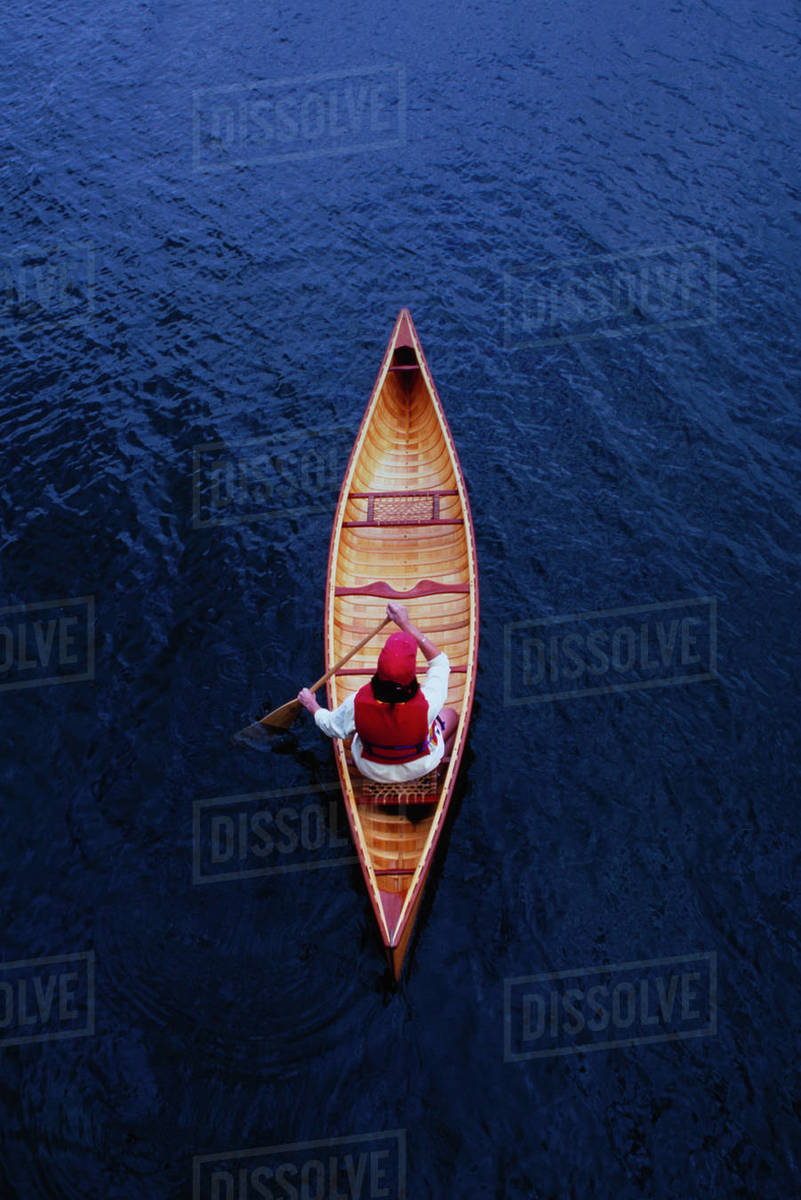 Overhead view of woman paddling canoe on Lake Placid - Stock Photo ...